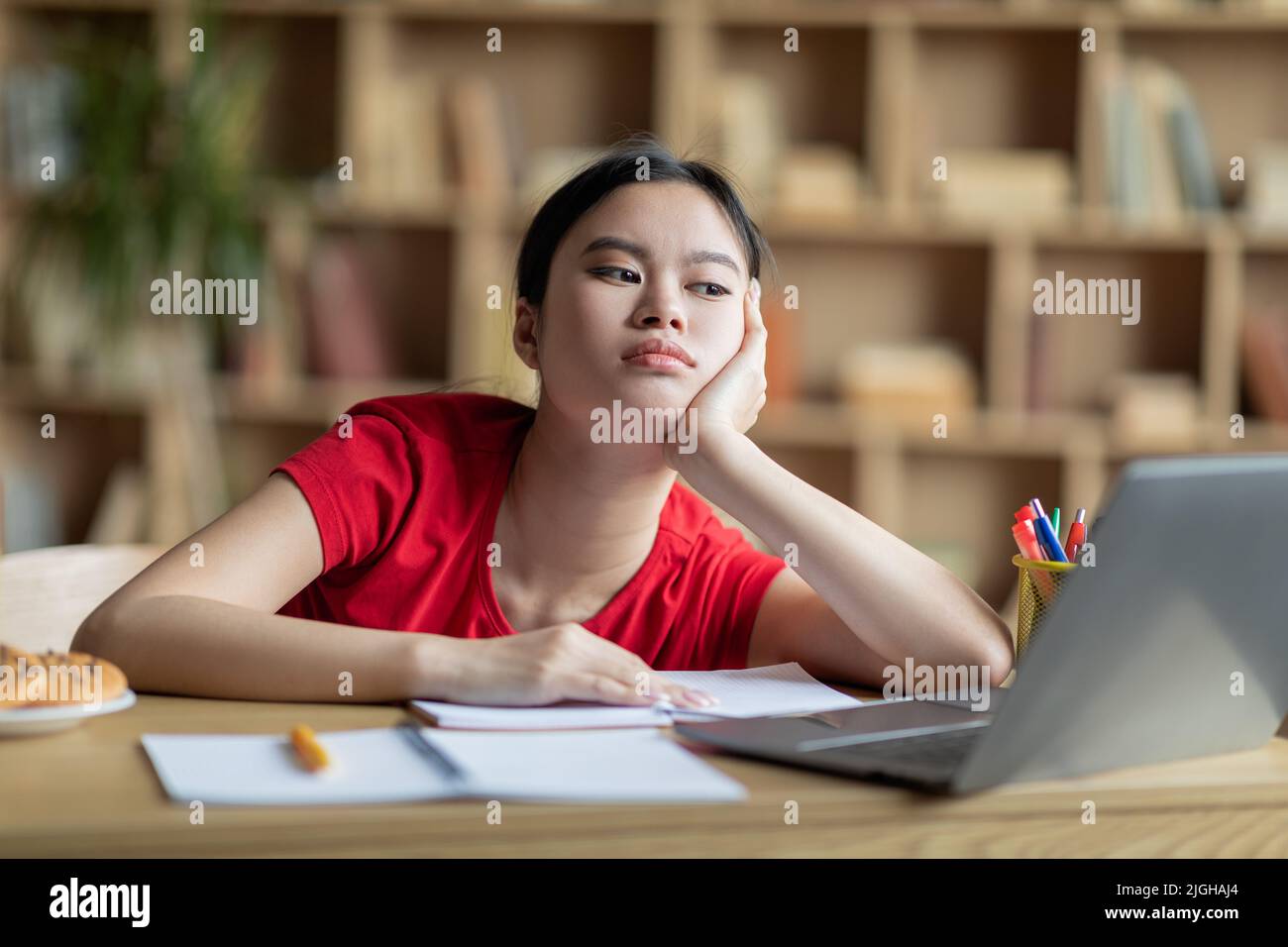 Online education at home. Boring tired asian woman watching video ...