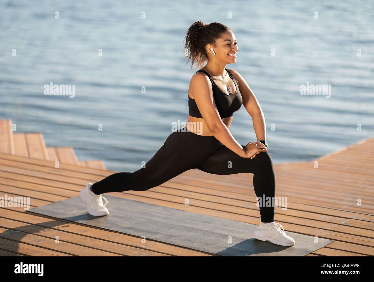 Motivated african american lady training outdoors, side view Stock ...
