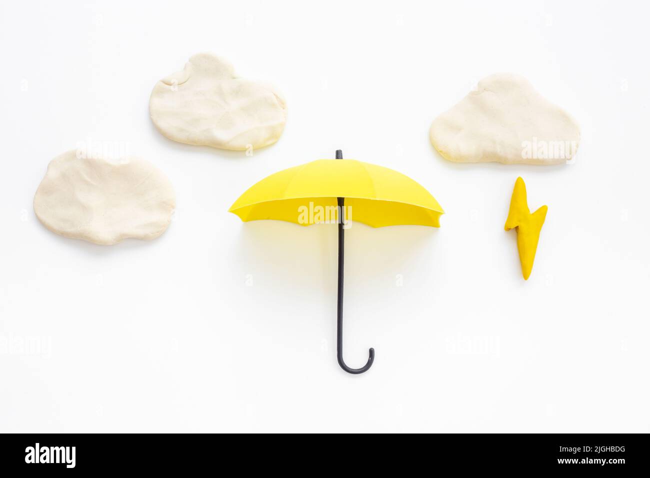 Plasticine clouds with lightning thunderbolt. Weather forecast concept ...