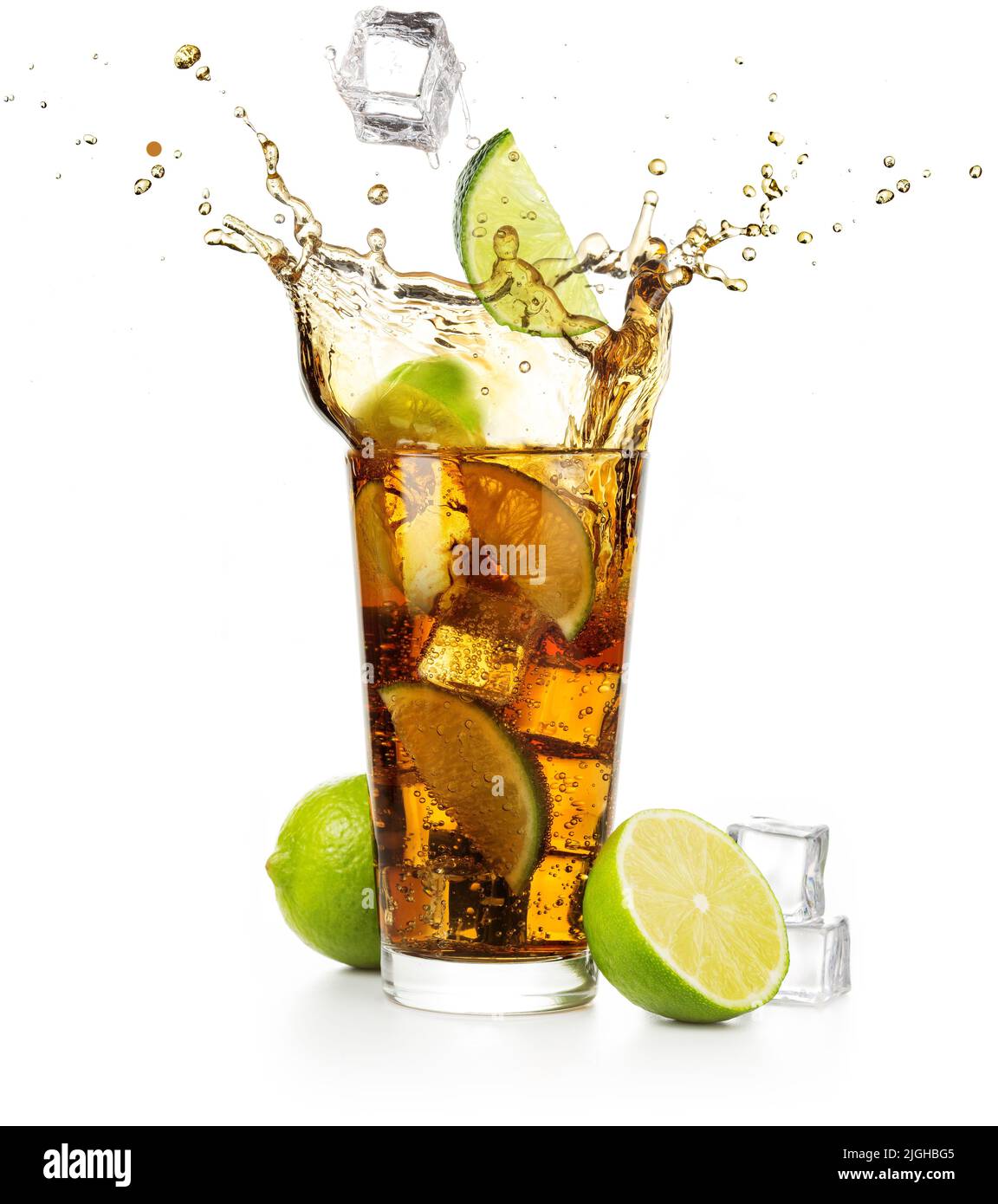 lime slice and ice cube falling into splashing cuba libre cocktail ...