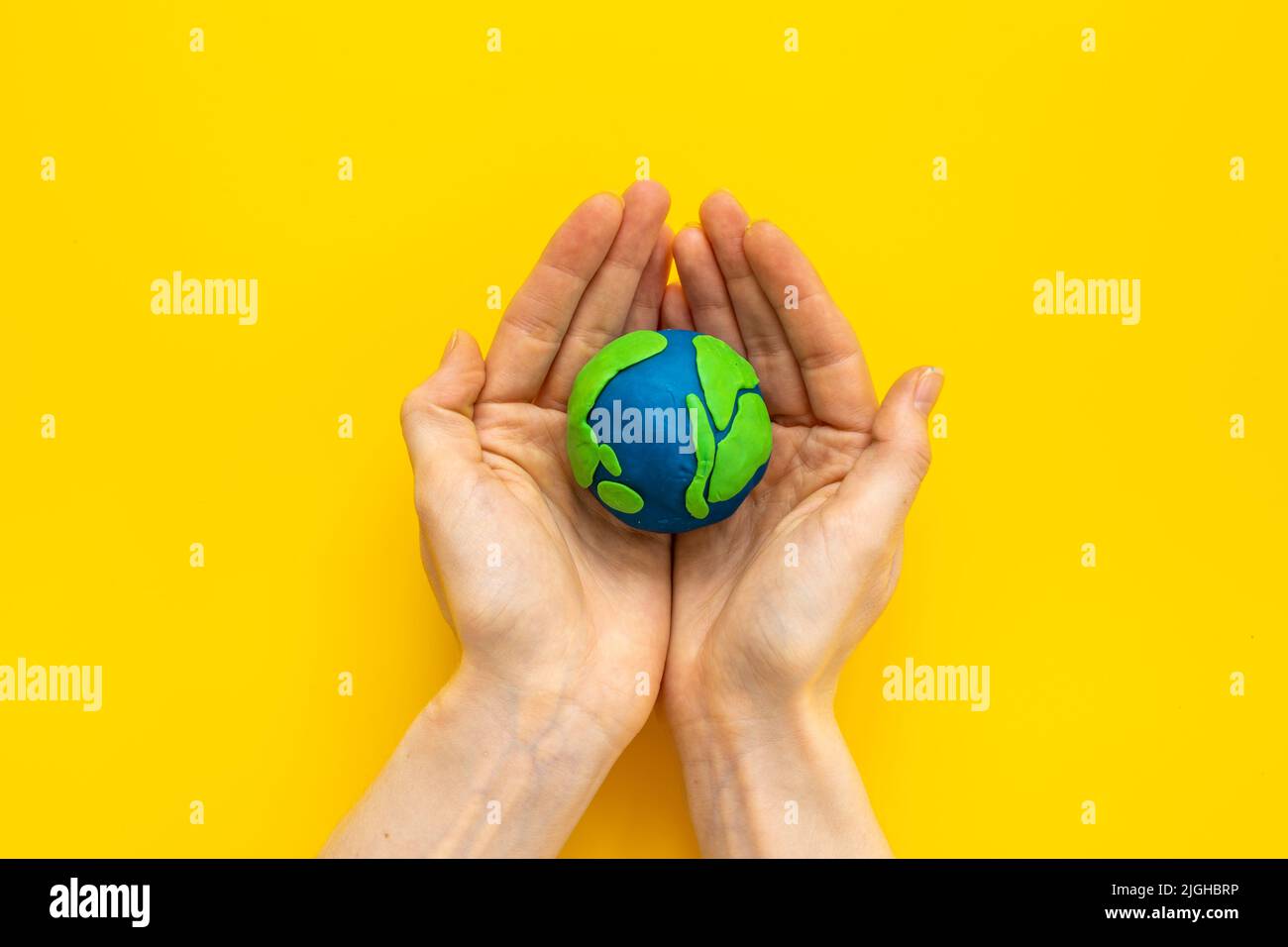 Plasticine world - planet Earth in hands. Eco care concept Stock Photo ...