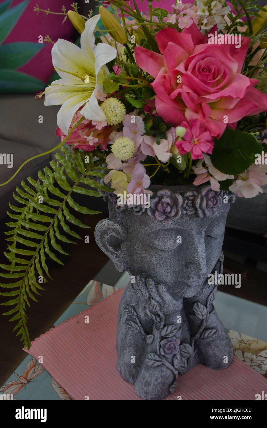 buddha statue with a bouquet of flowers, spa wellness tranquil scene ...