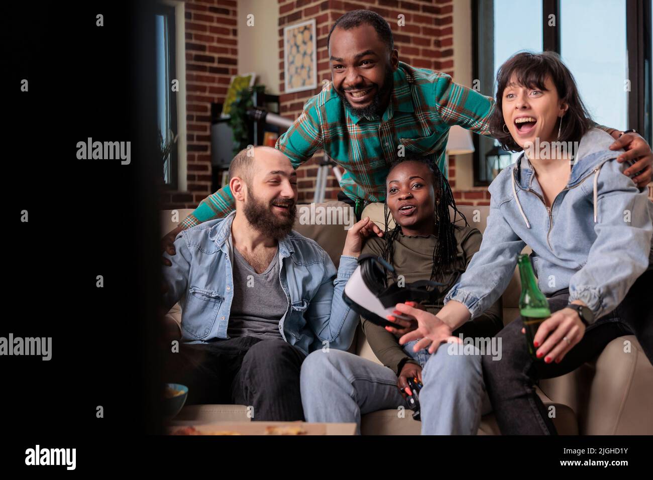 Cheerful men and women feeling happy about winning video games, having ...