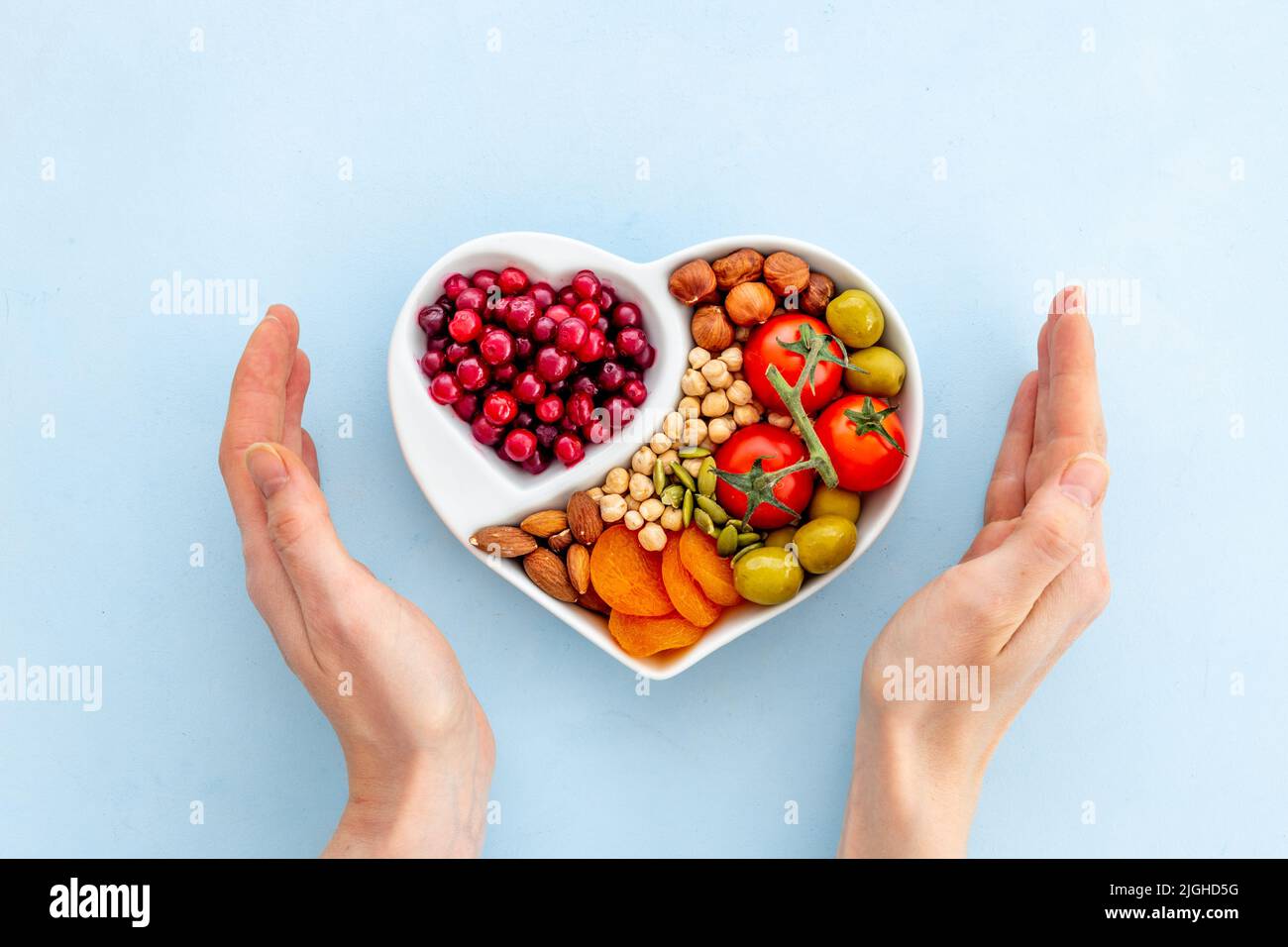 Hands with heart shaped dish of healthy diet food Stock Photo - Alamy