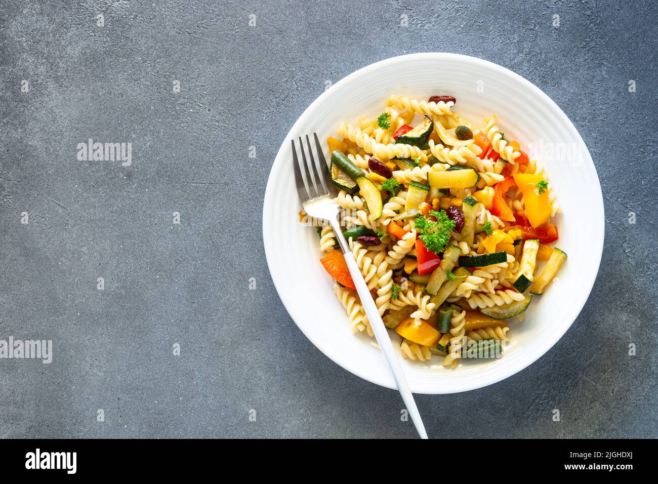 Vegan pasta fusilli with vegetables, zucchini, paprika and grean beans ...