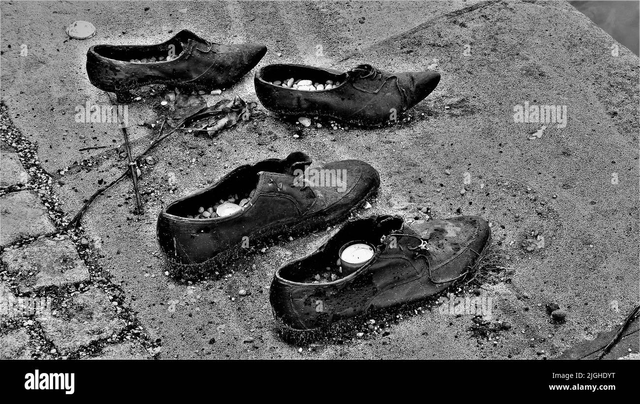 The grayscale of the two pairs of old shoes with candles inside - shoes ...