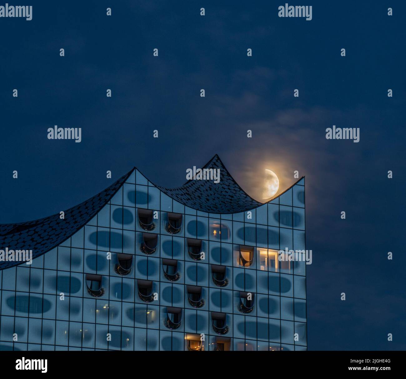 The halfmoon is shining trough the Clouds and matches the Shape of the ...