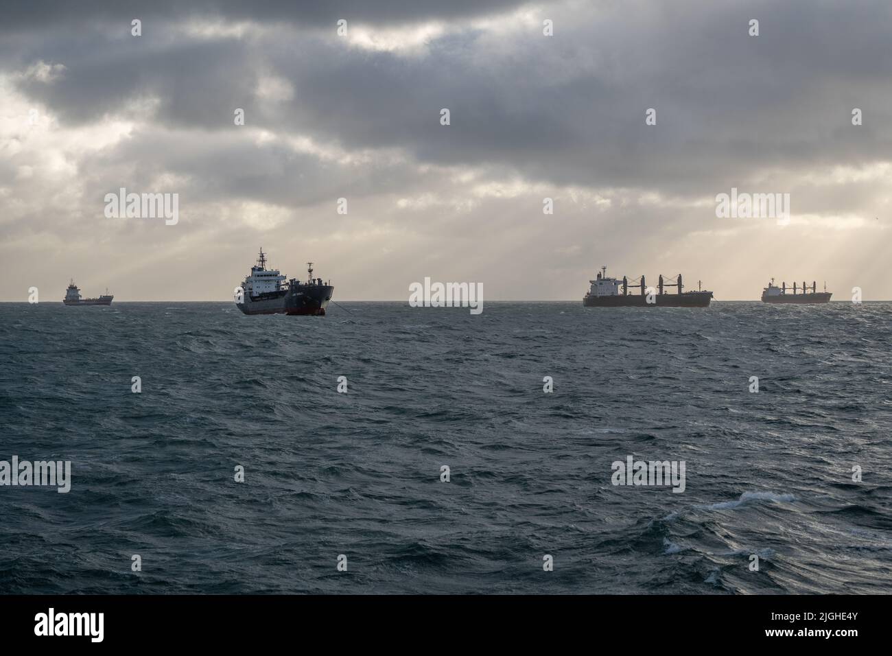4 Vessels waiting on the Sea Stock Photo - Alamy