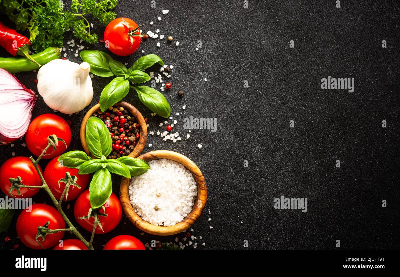 Food cooking background on black stone table Stock Photo - Alamy
