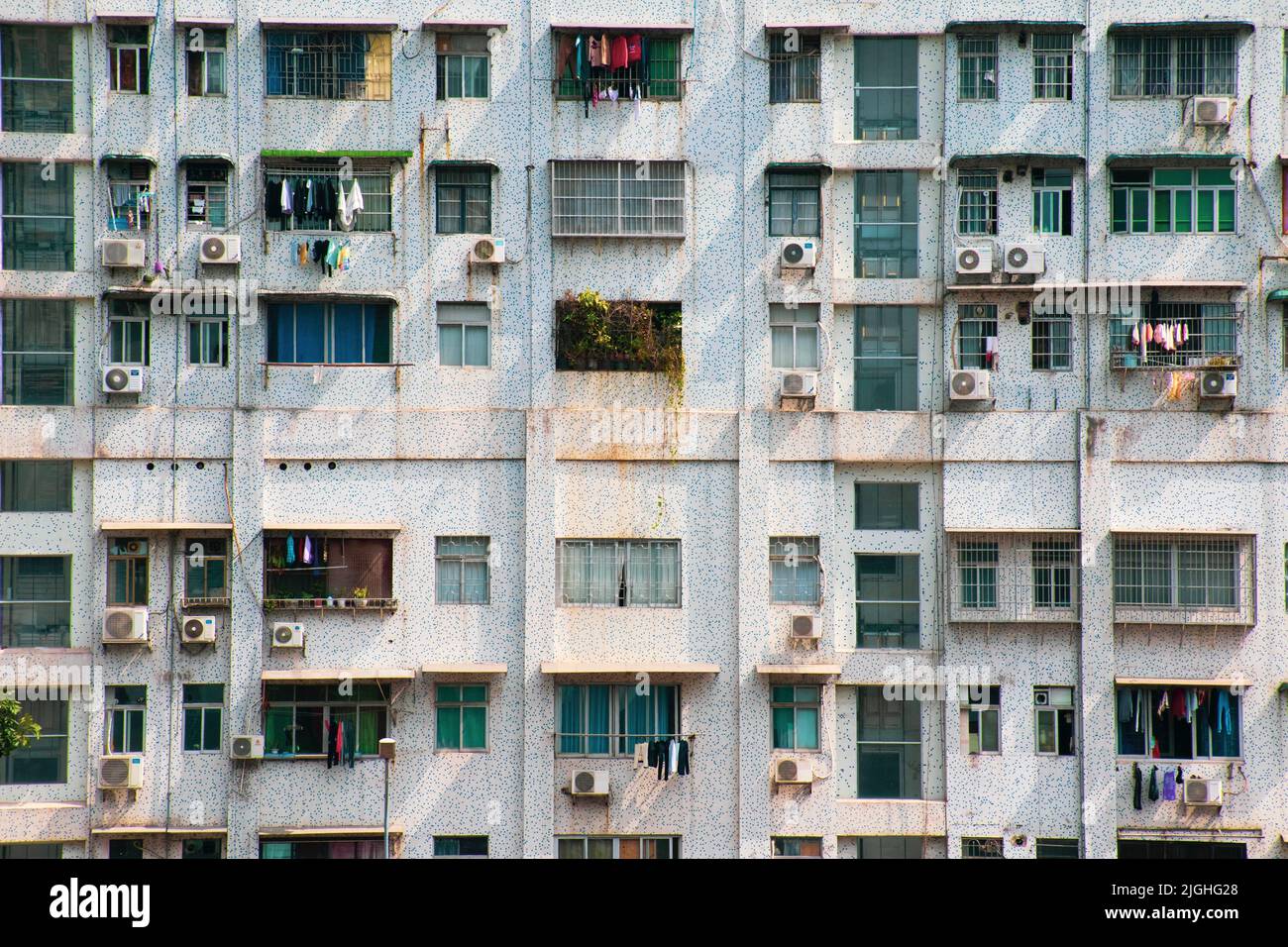 A view of an old apartment building with various windows Stock Photo ...