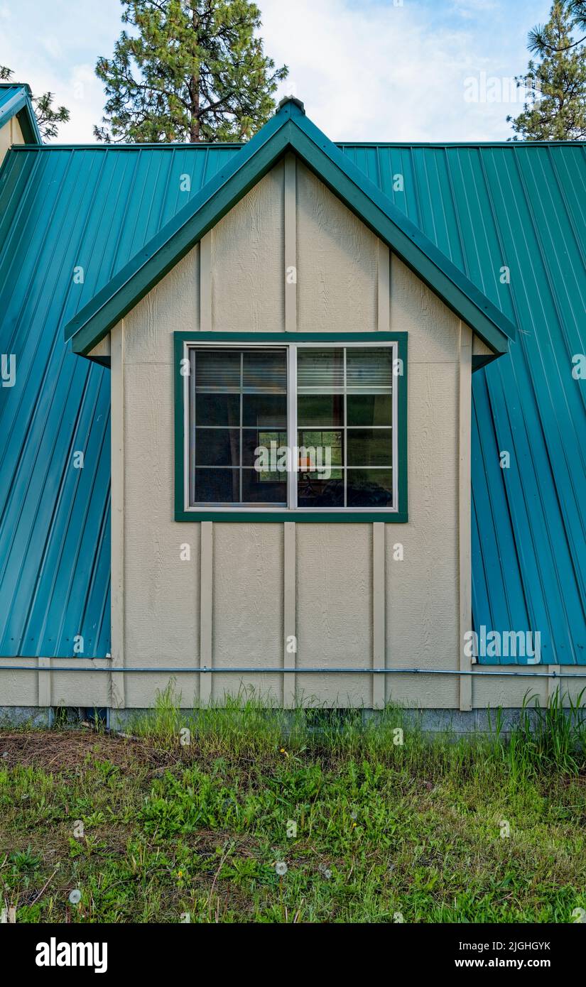Dormer on the first floor of a cottage with a standing seam metal roof ...