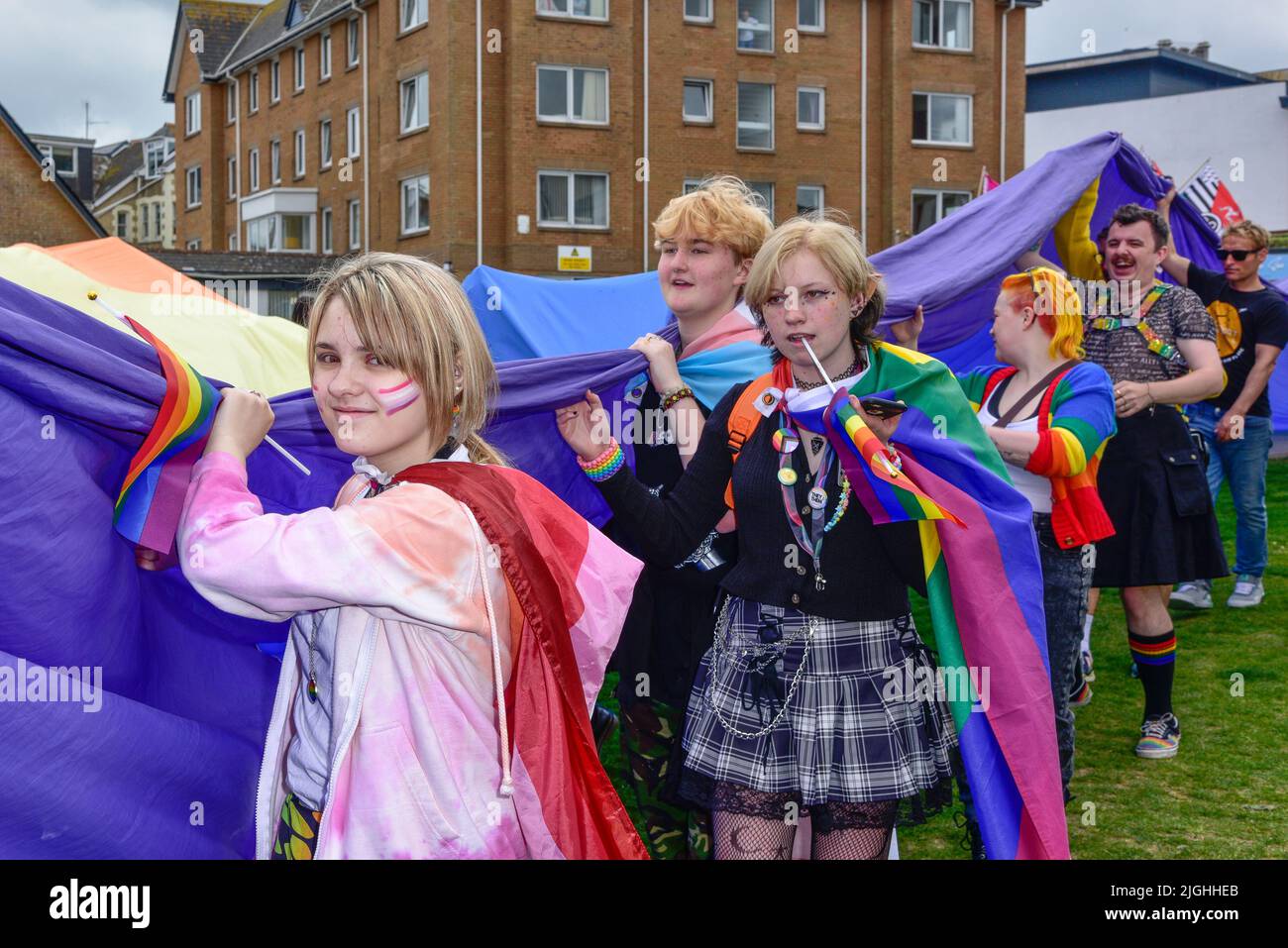 Happy participants in the vibrant colourful Cornwall Prides Pride parade in Newquay Town centre ...