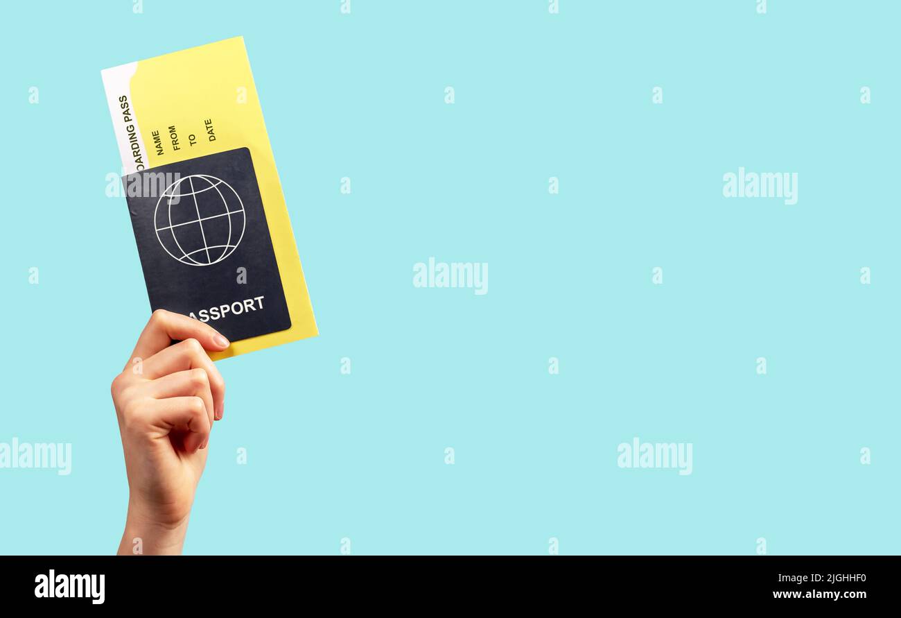 Banner with hand holding passport and boarding pass on turquoise ...