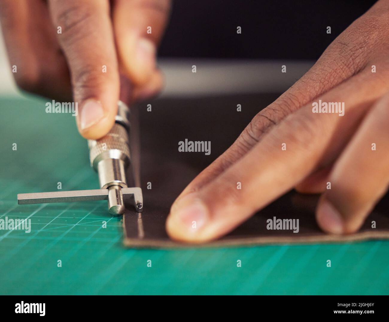Its hands-on work. an unrecognizable male designer working with leather ...