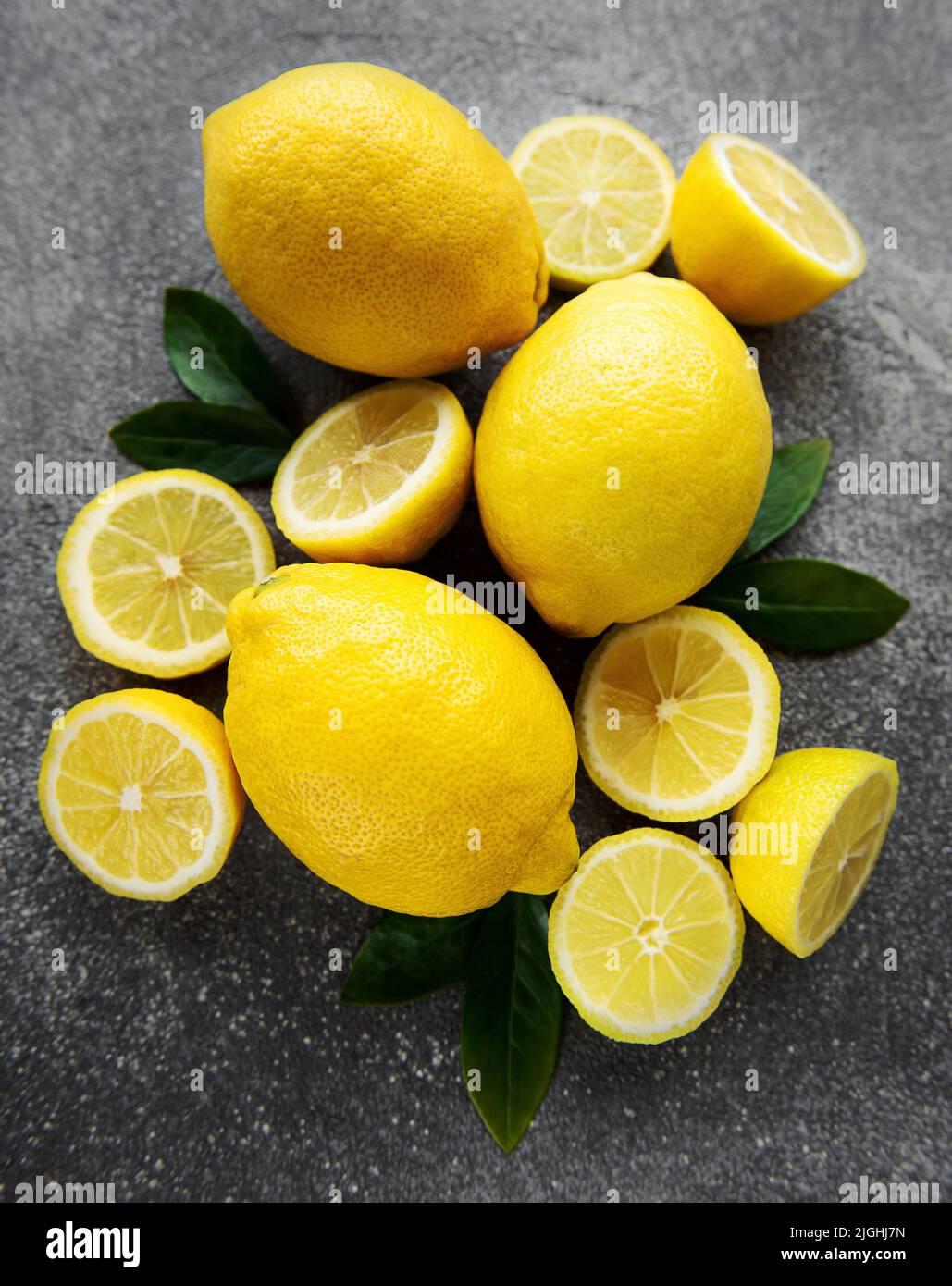 Fresh ripe lemons on dark concrete background Stock Photo - Alamy
