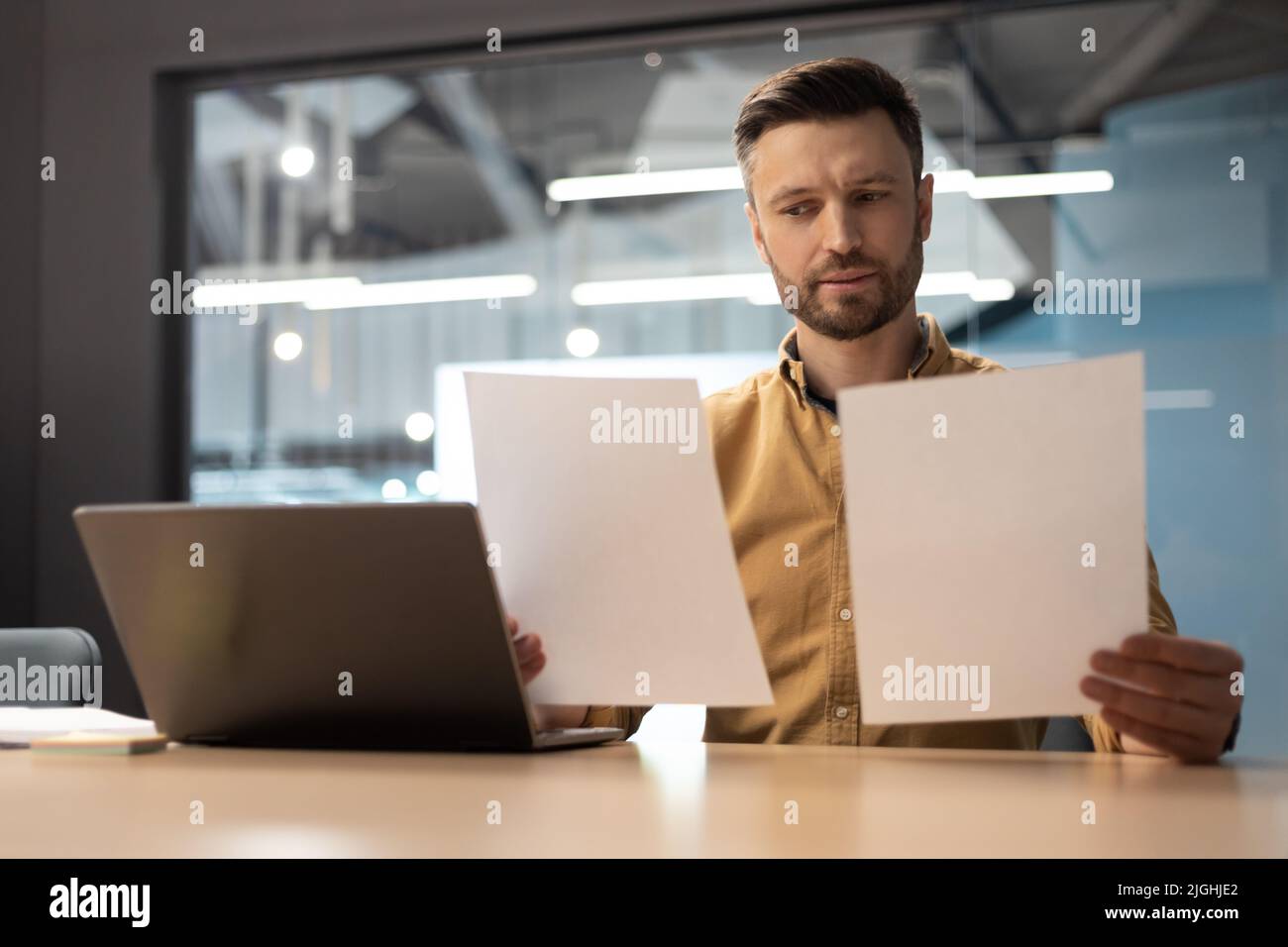 Businessman holding two paper hi-res stock photography and images - Alamy