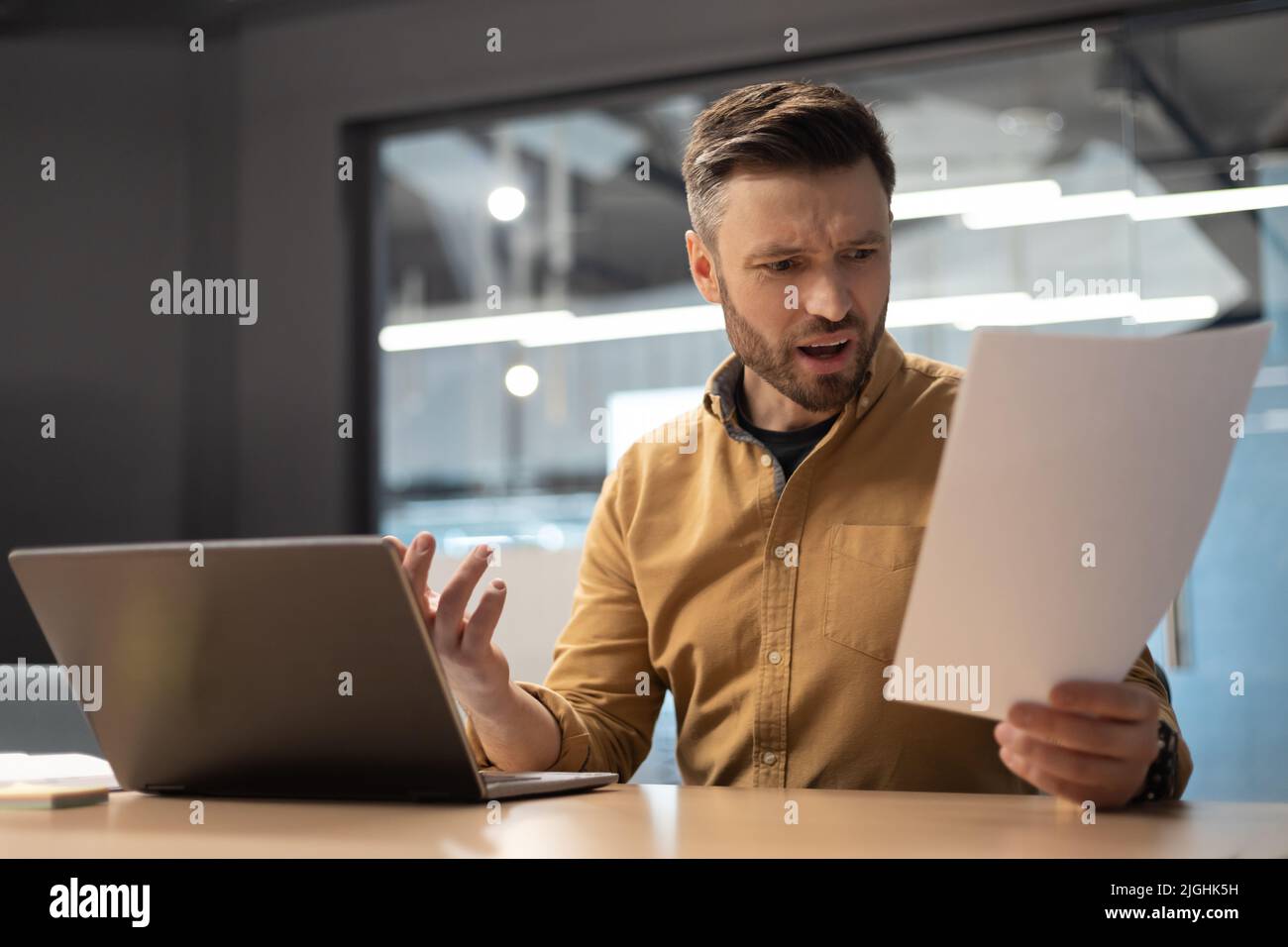Shocked Businessman Holding Papers Having Issue Sitting In Modern ... Shocked Businessman Holding Papers Having Issue Sitting In Modern ...