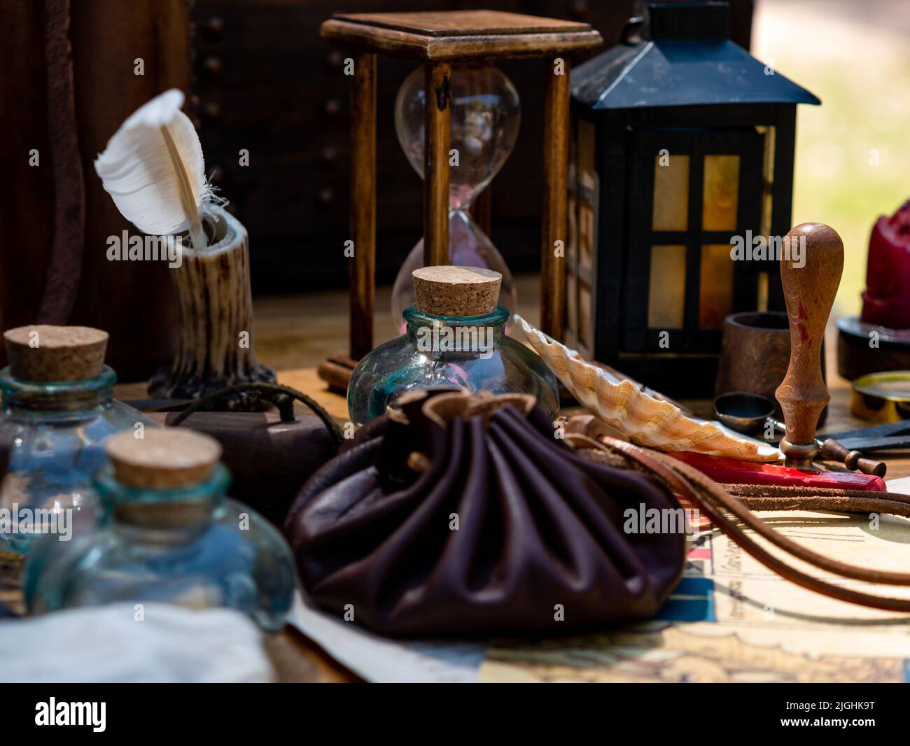 scribe's table with goose feather pen, hourglass Stock Photo - Alamy