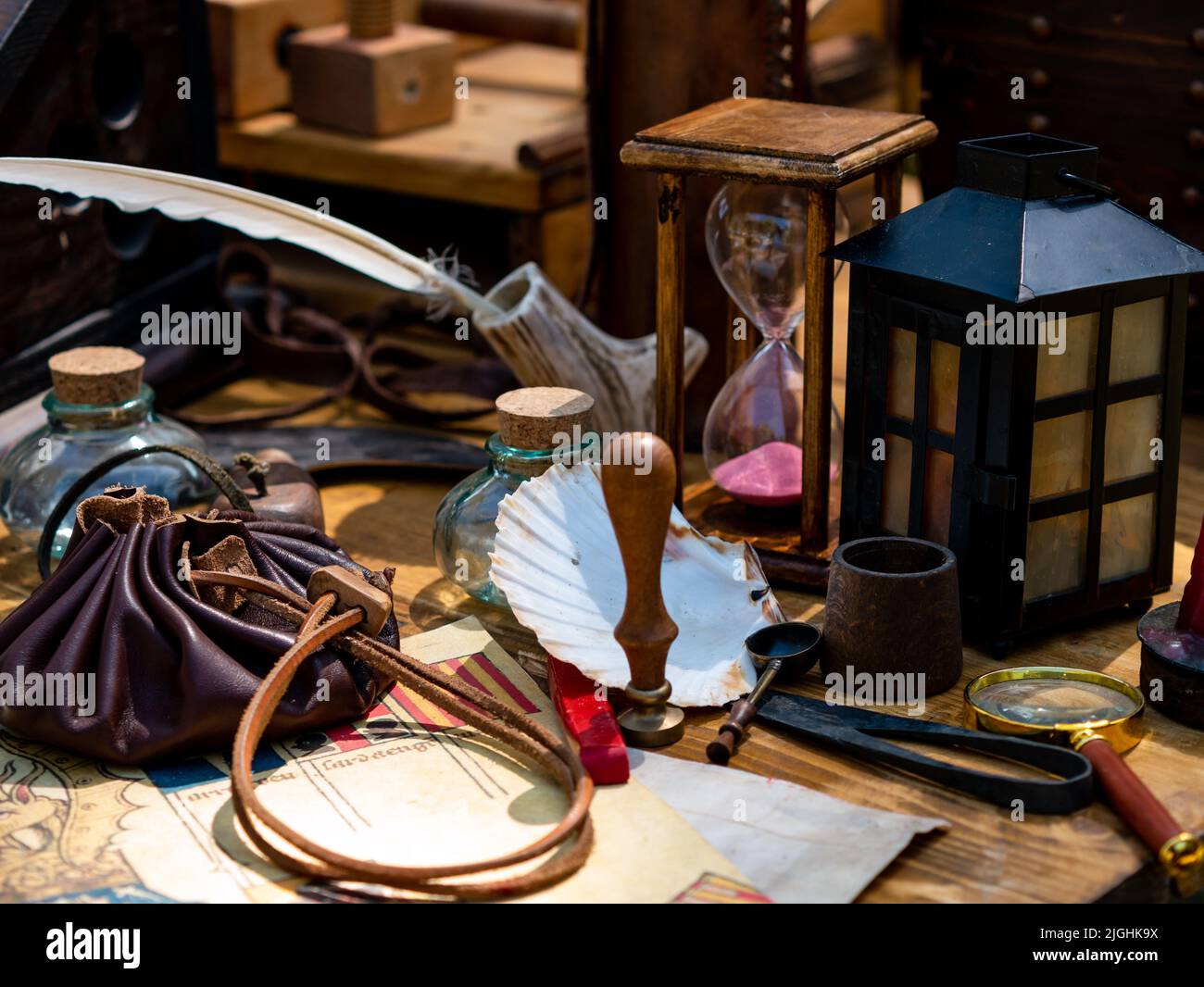 scribe's table with goose feather pen, hourglass Stock Photo - Alamy