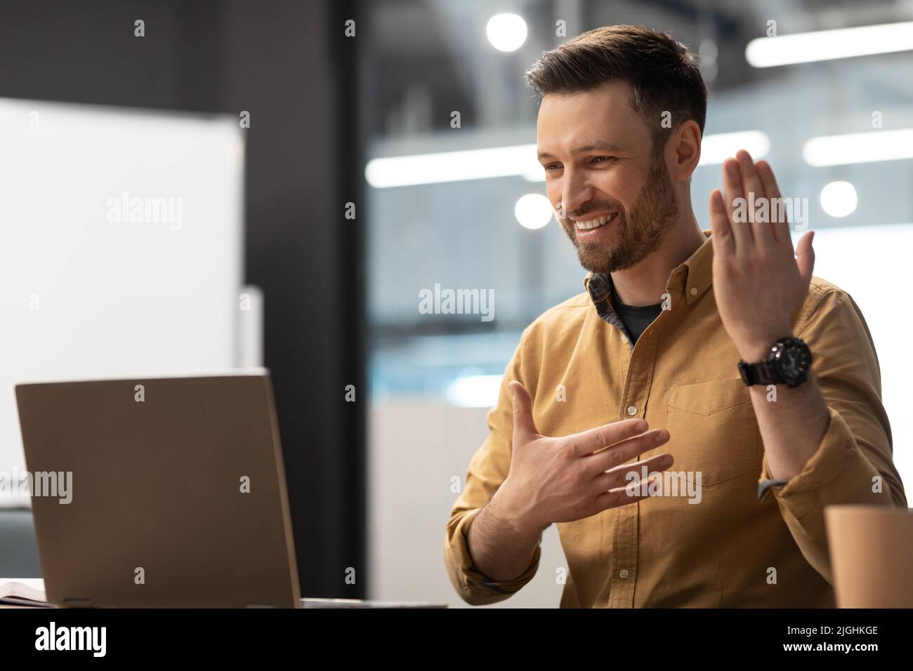 Male Office Worker Making Video Call Via Laptop At Workplace Stock ... Male Office Worker Making Video Call Via Laptop At Workplace Stock ...