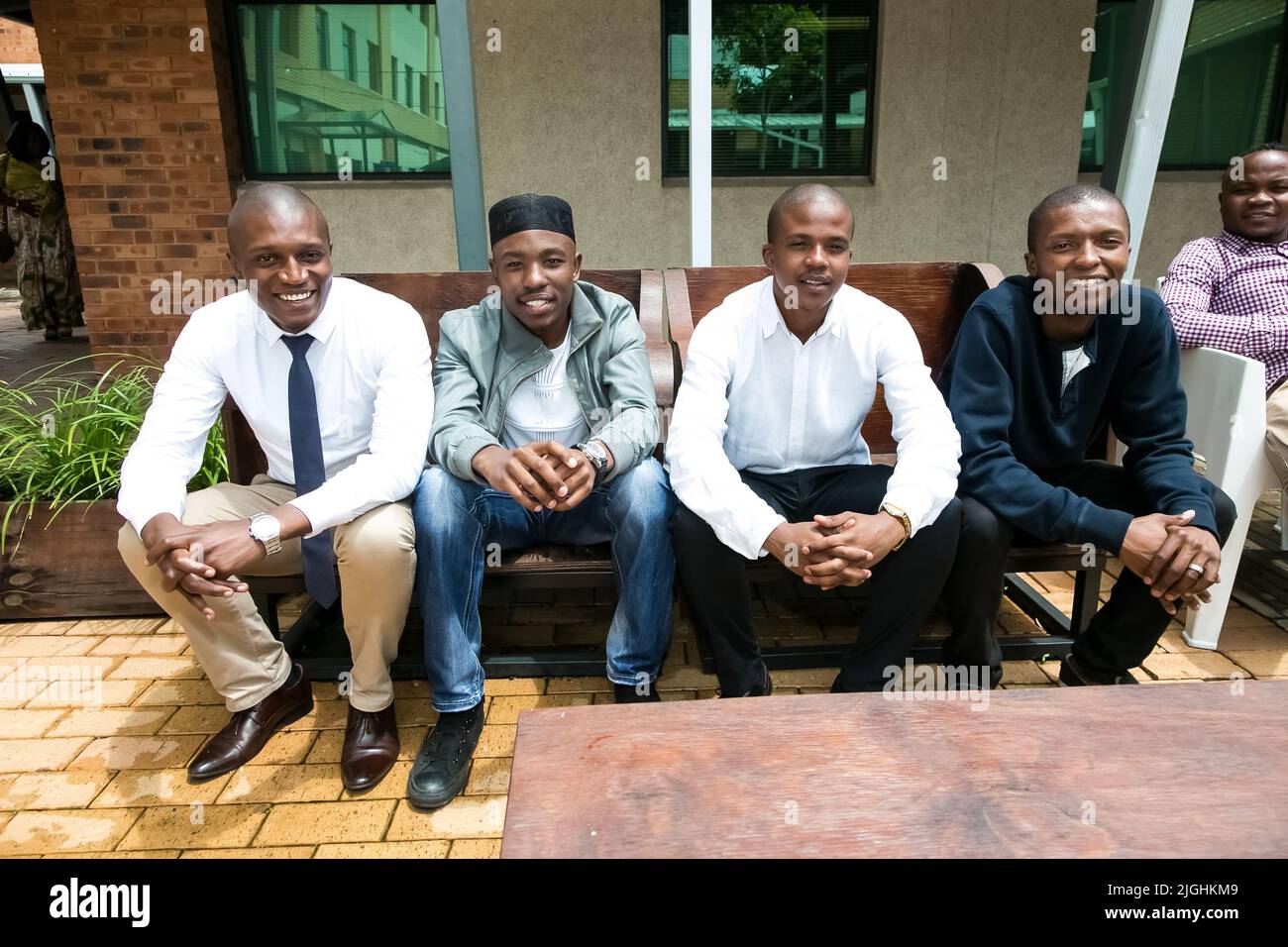 A group of male African students socialising and posing together on ...