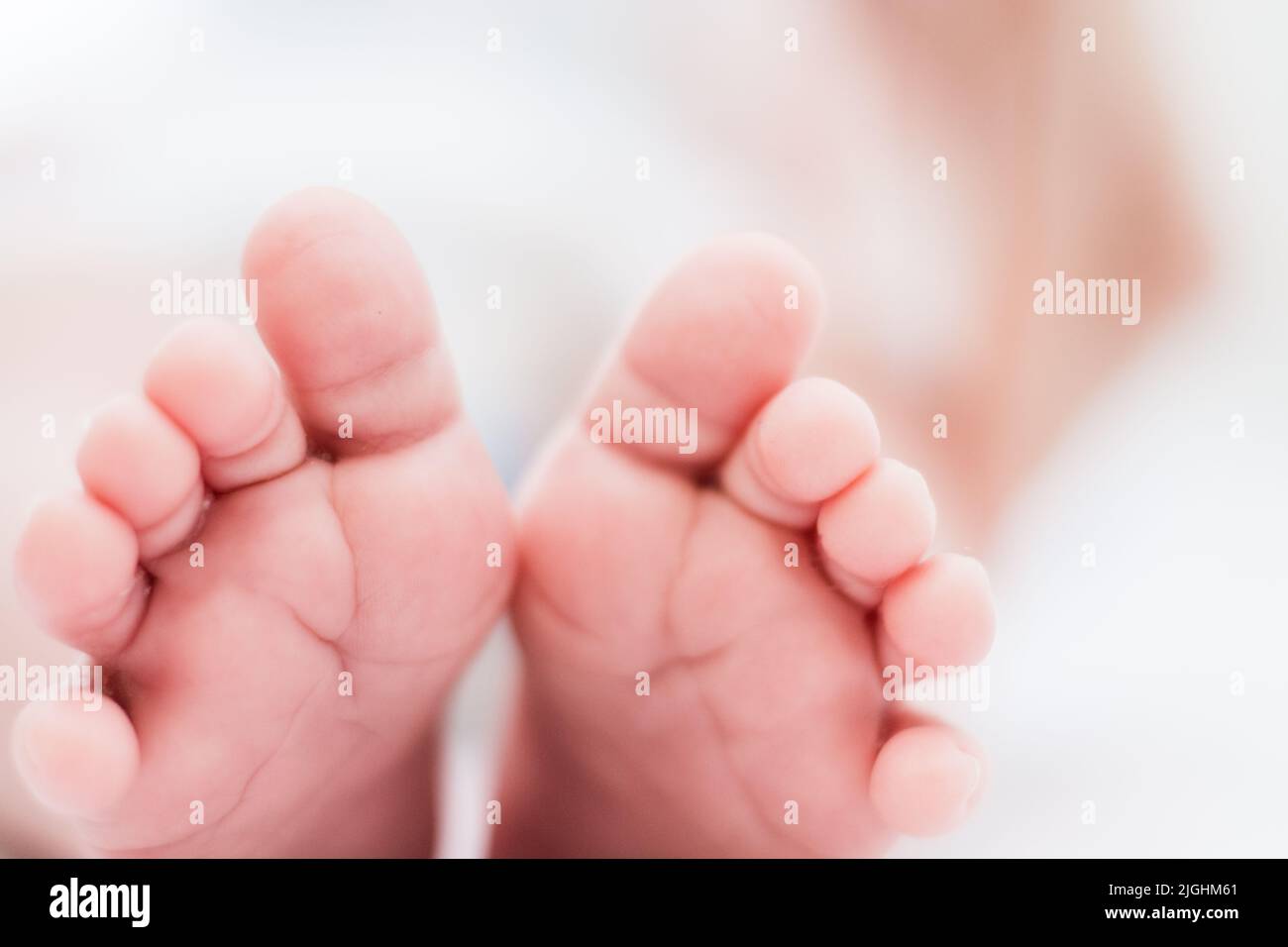 A closeup of child's feet from below on blur background Stock Photo - Alamy