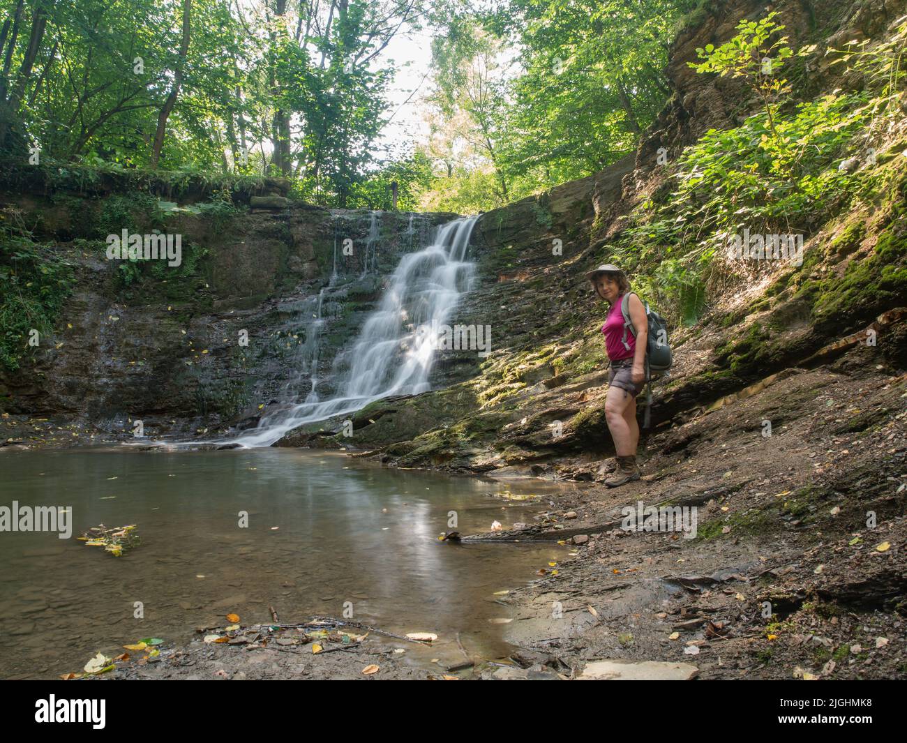 Tourist during trekking at the cascades of the waterfall in Iwli, Low ...
