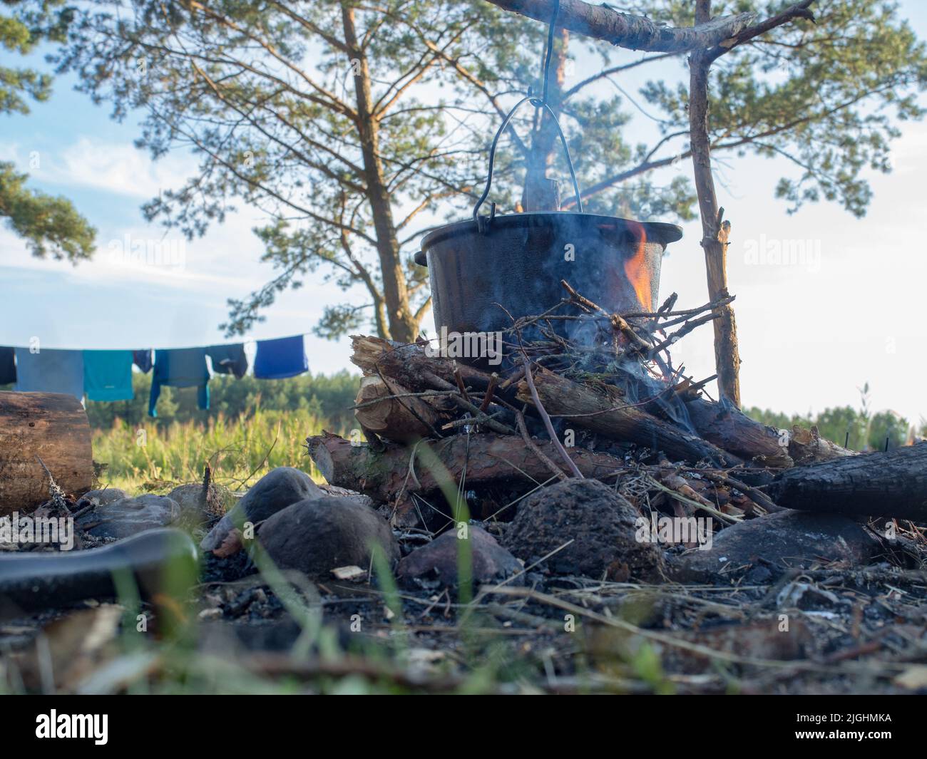 Cooking a meal on a campfire in metal vessels during a canoeing ...