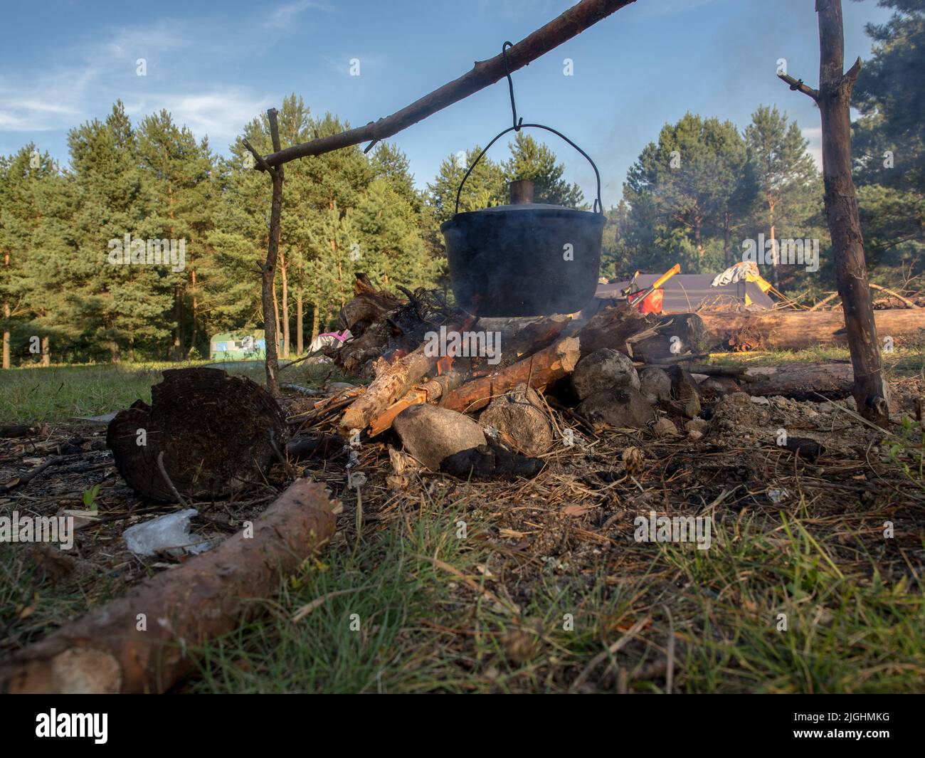 Cooking a meal on a campfire in metal vessels during a canoeing ...