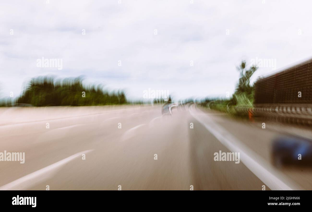 Blur defocused view of large highway with the silhouette of multiple ...