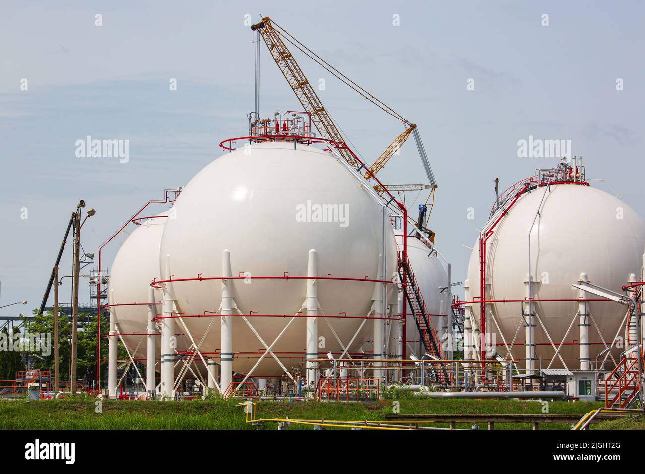 White spherical propane tanks containing fuel gas pipeline and ...