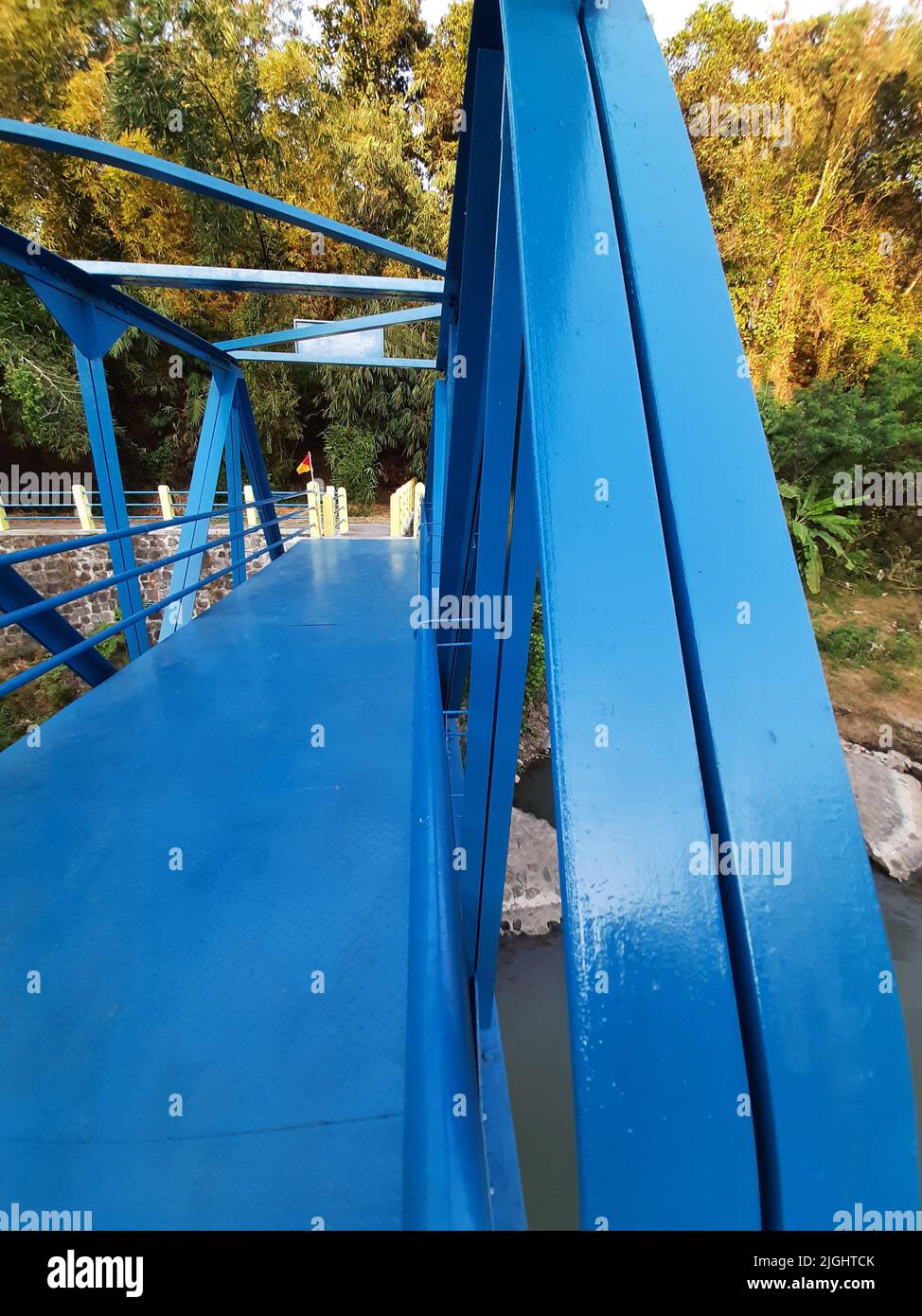 Vertical view through a blue bridge for pedistrian and bikes over a ...