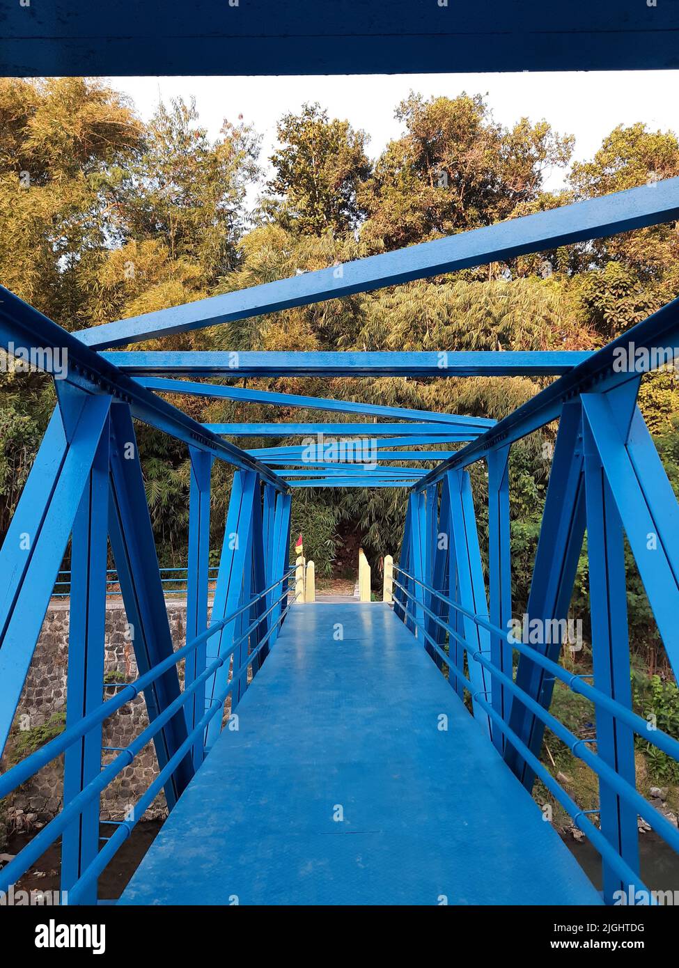 Vertical view through a blue bridge for pedistrian and bikes over a ...