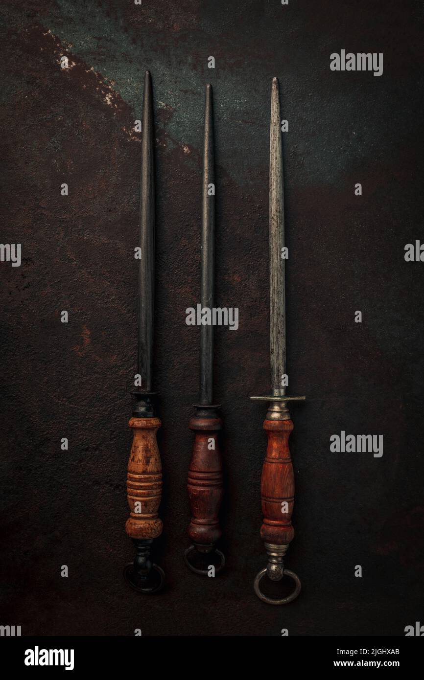 collection of three knife sharpeners with carbon steel blade and wooden ...