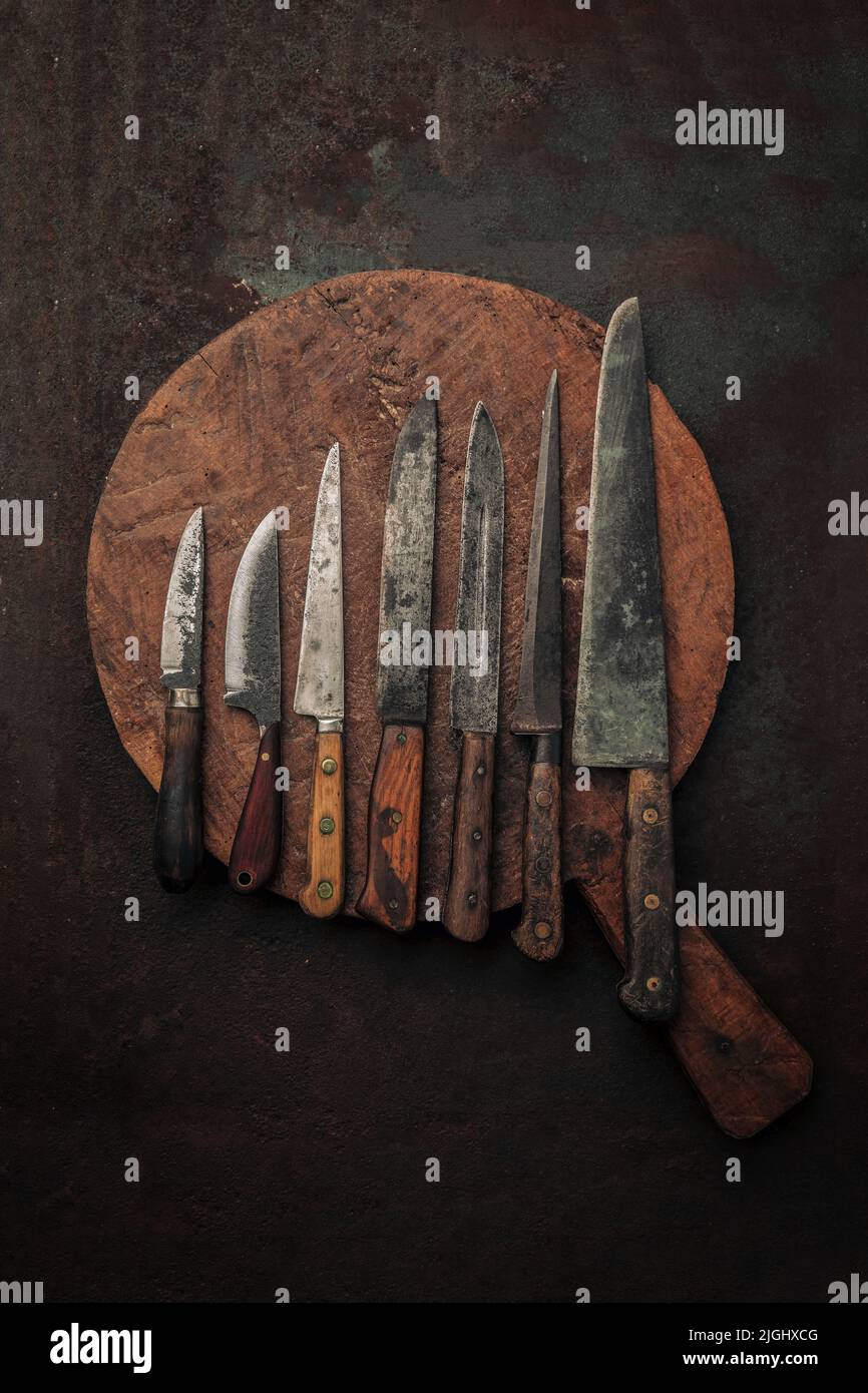 cooking concept illustrated by vintage set of carbon steel blade knives ...