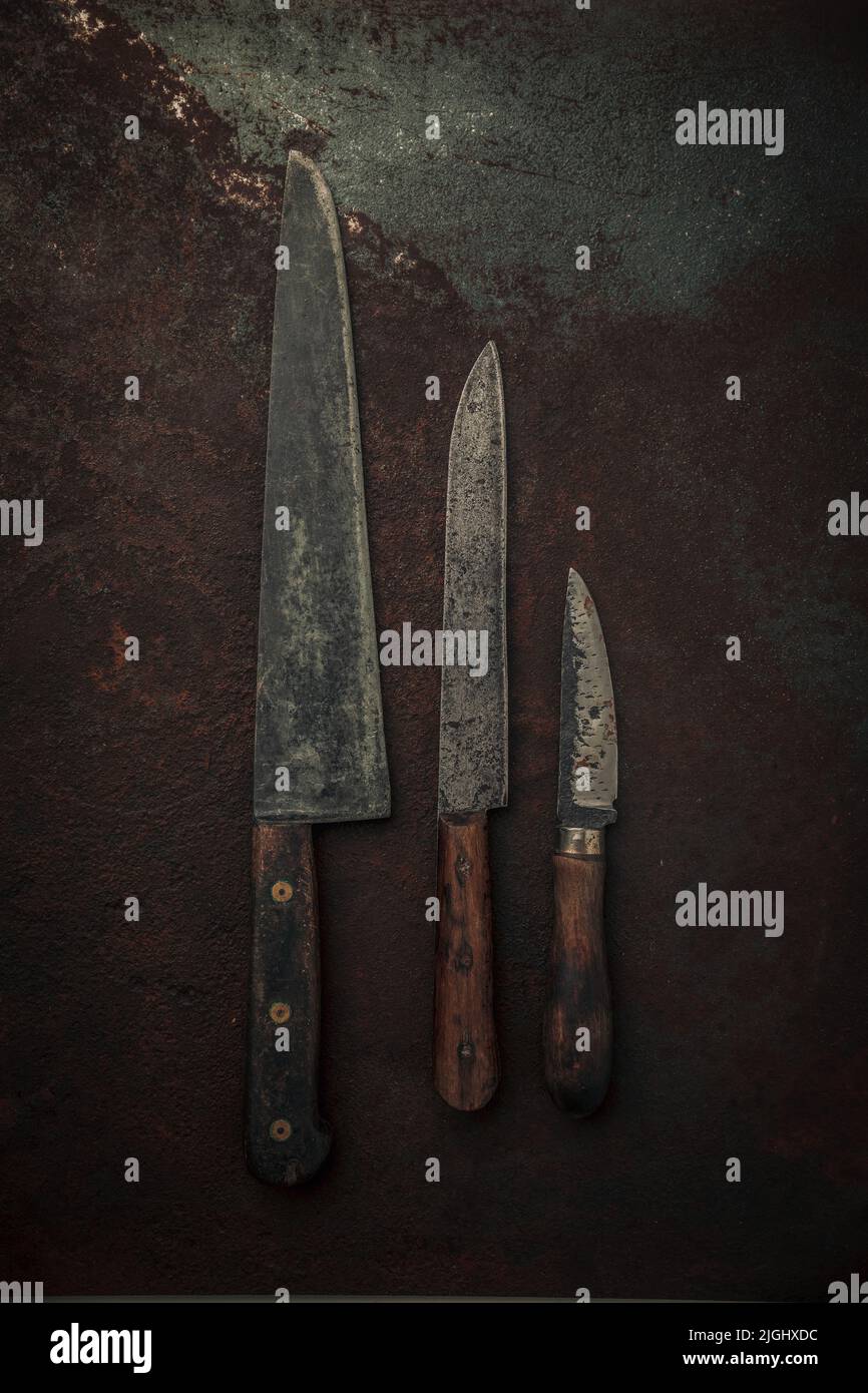 table top view of three rustic knives with carbon steel blade and ...