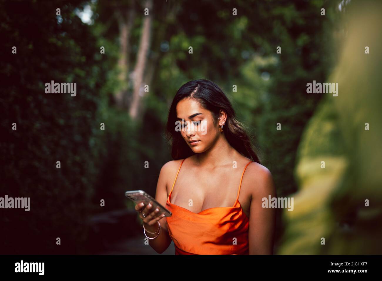 Portrait of beautiful young mixed race woman using cell phone Stock ...