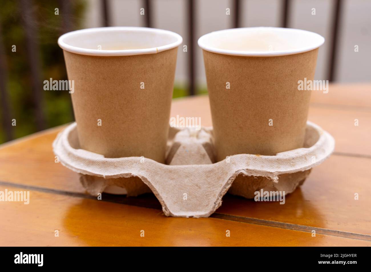 paper cups with coffee on the table of an outdoor cafe. Takeaway food ...