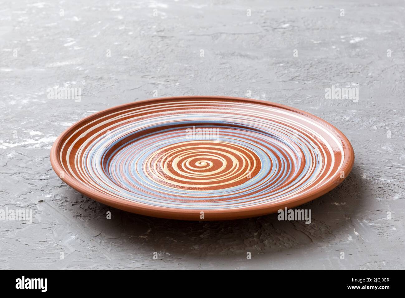 Perspective view of empty colorful plate on cement background. Empty ...