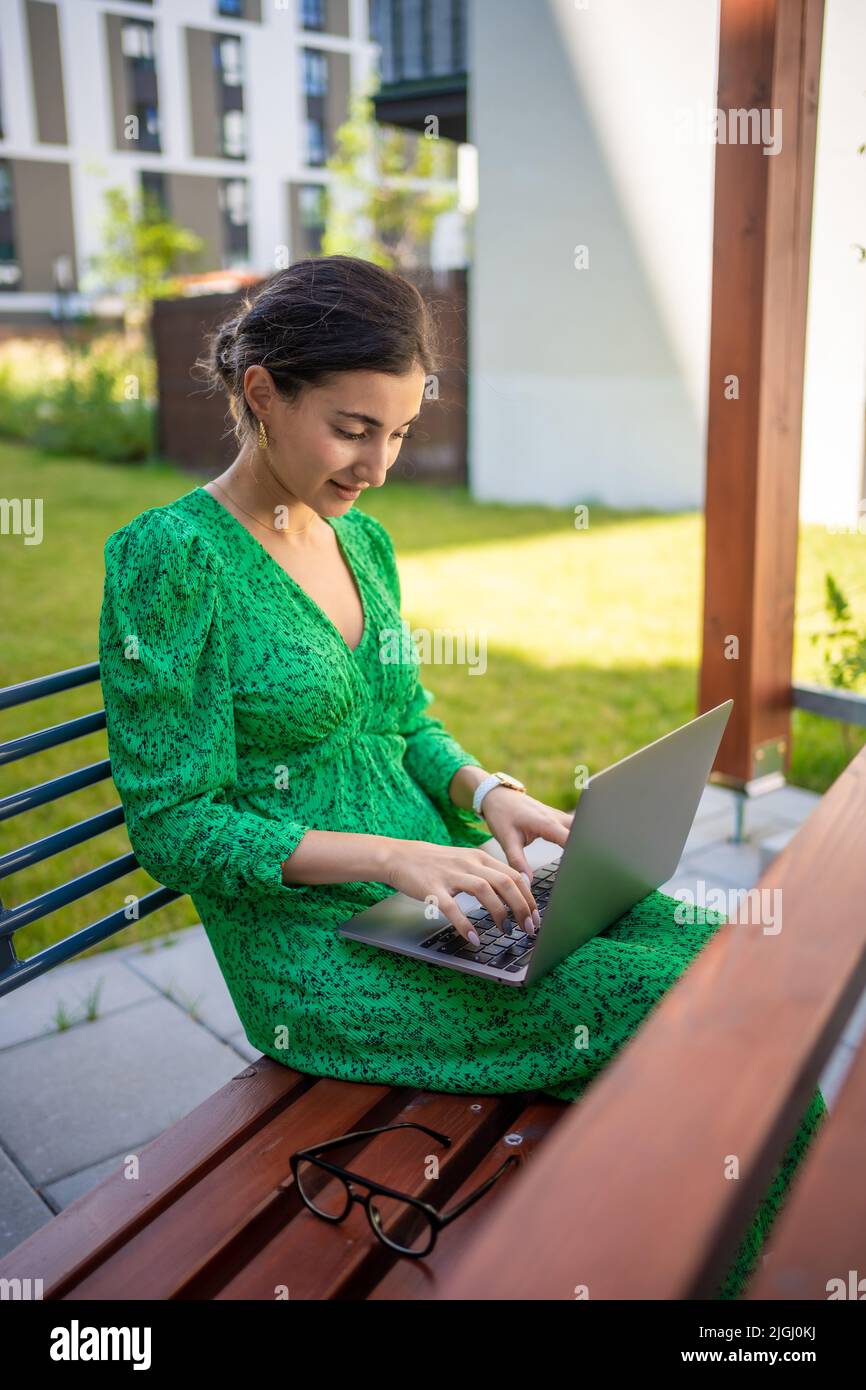 Caucasian woman working with laptop computer outside office Stock Photo ...