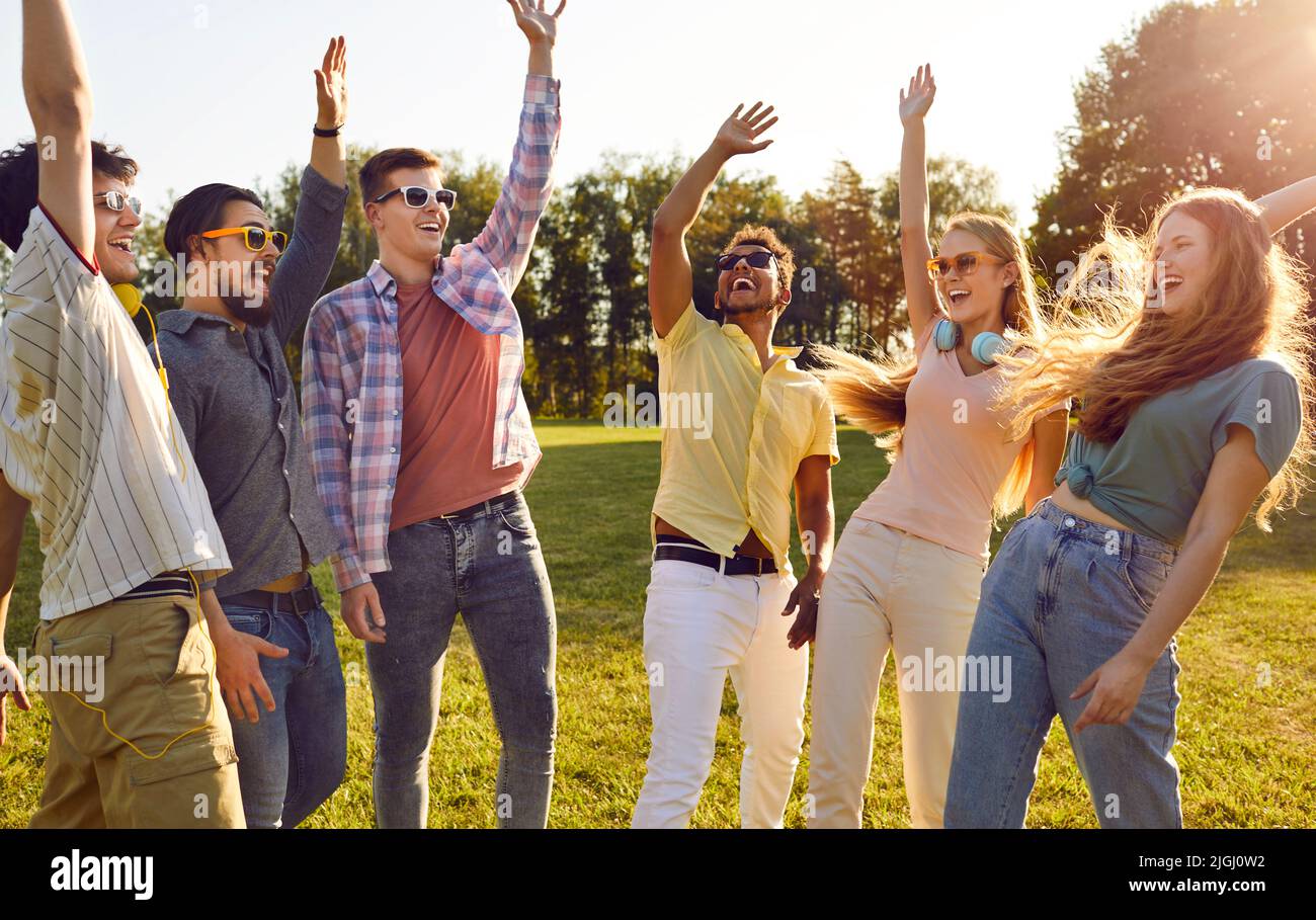 Group of happy young people have fun together while walking in park on ...