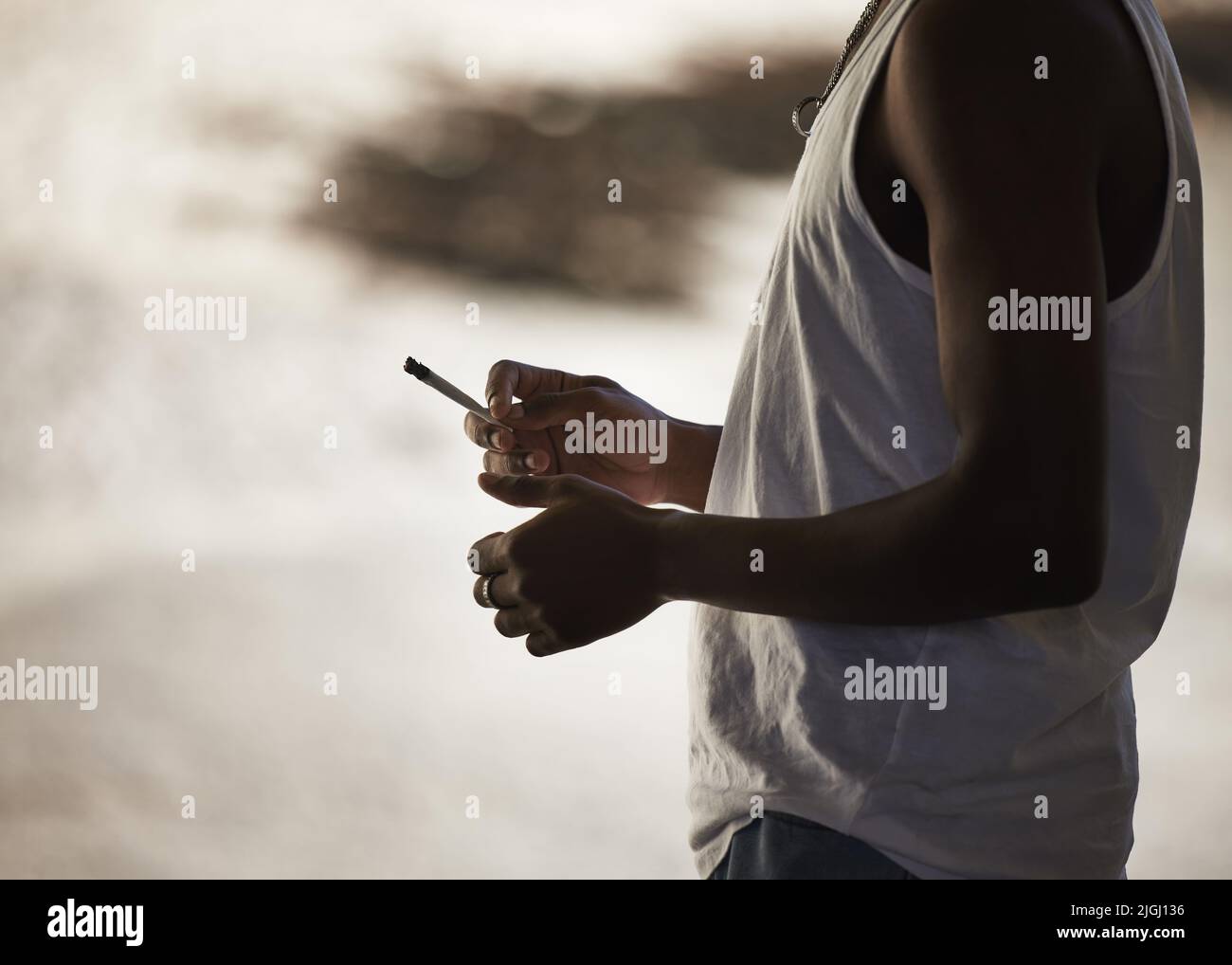 Time to take the edge off. an unrecognisable man smoking a marijuana ...