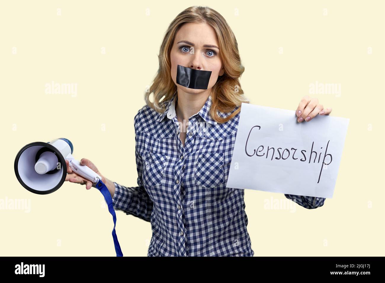 Upset young woman with black tape over mouth. Isolated on white ...