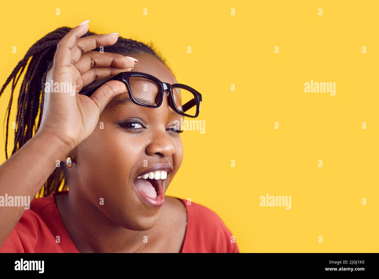 Portrait of happy African American woman winking her eye on copy space ...