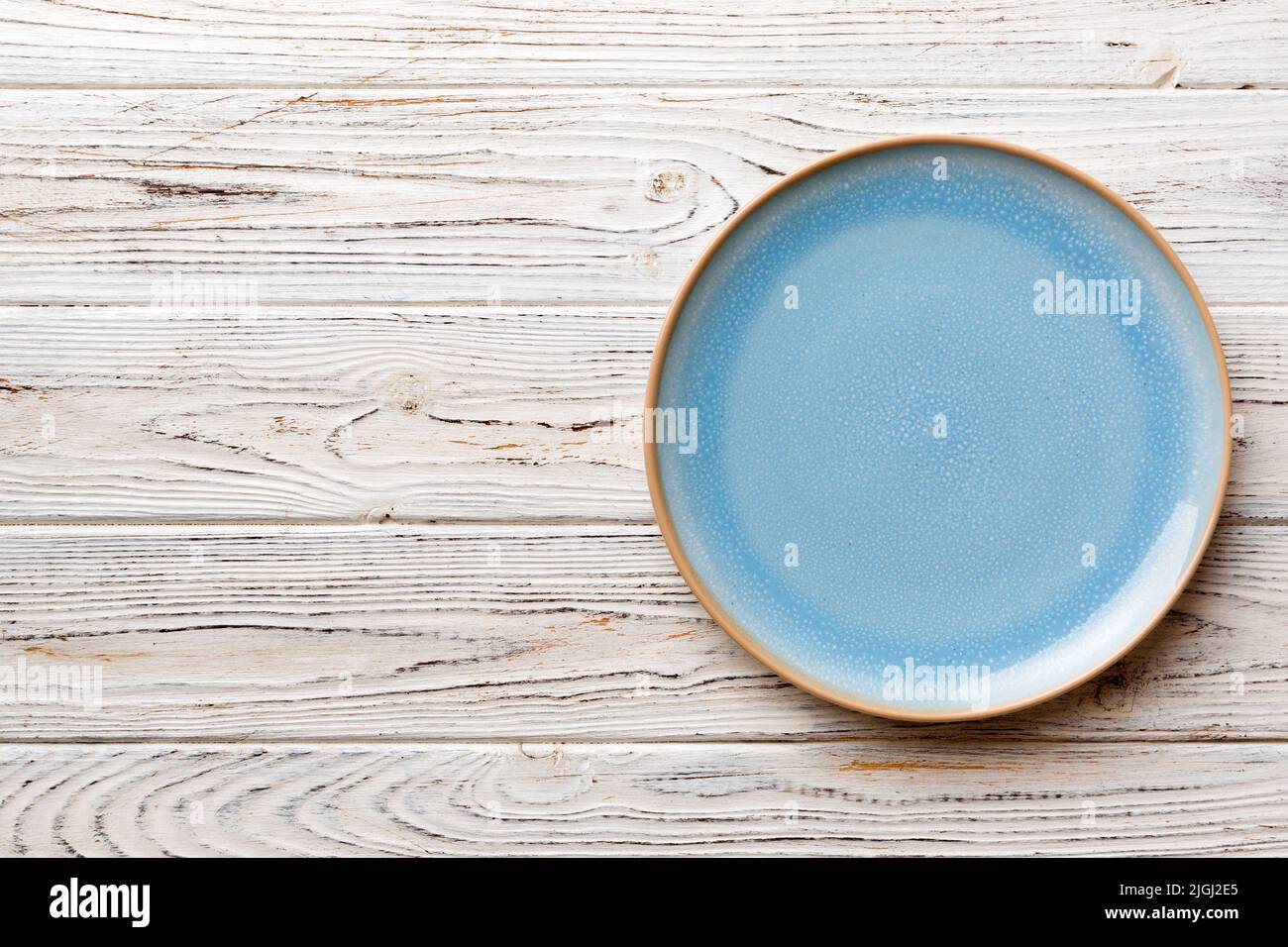 Top view of empty blue plate on wooden background. Empty space for your ...