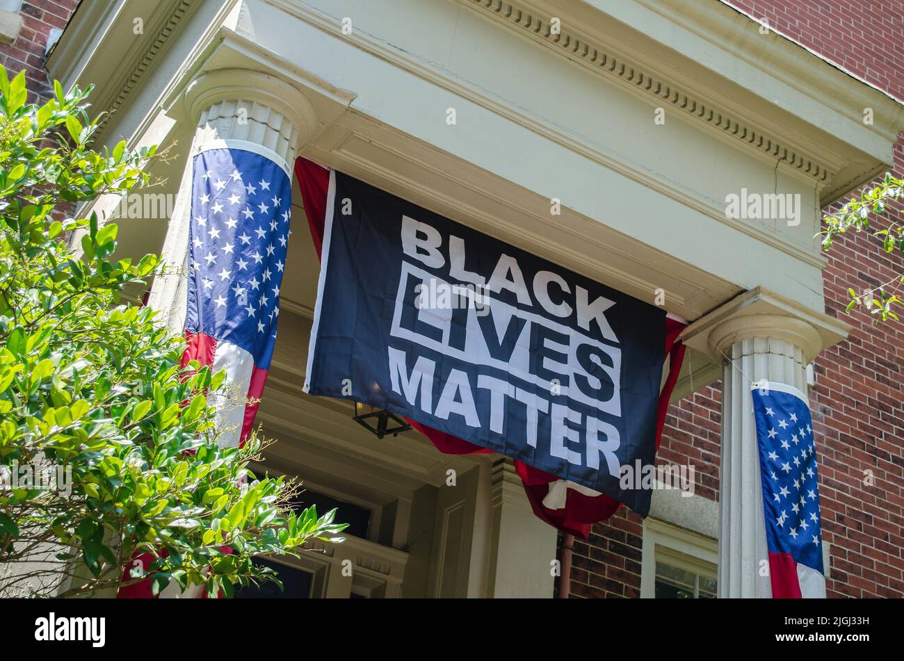 A low angle shot of a Black Lives Matter banner on a building with ...