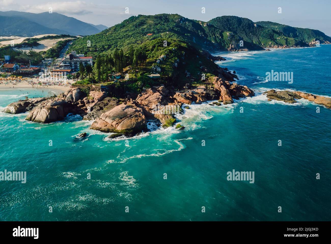 Scenic landscape with Joaquina beach, rocks, mountains and blue ocean ...