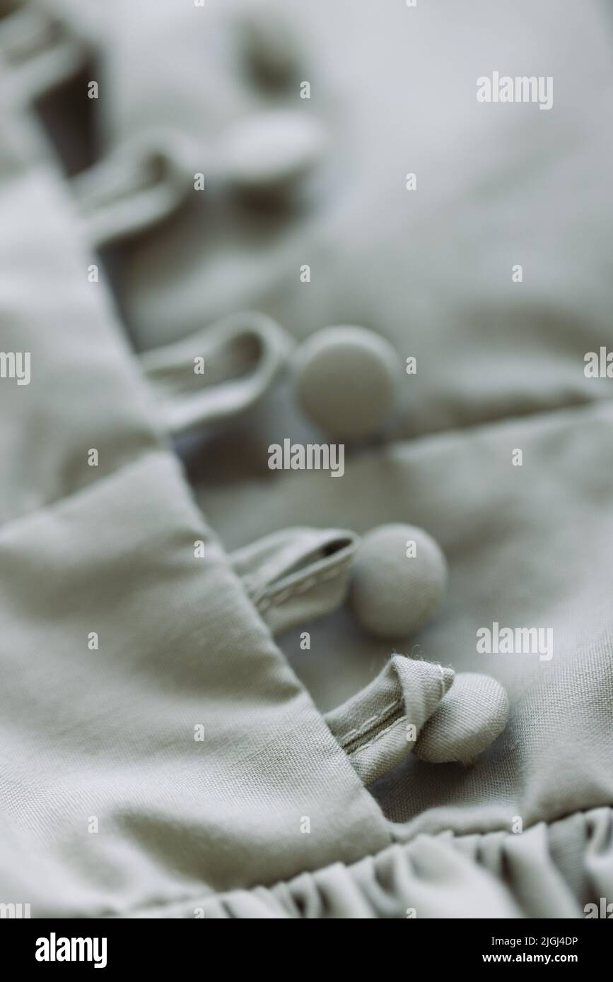 Buttons on the cotton dress closeup. Selective focus Stock Photo - Alamy