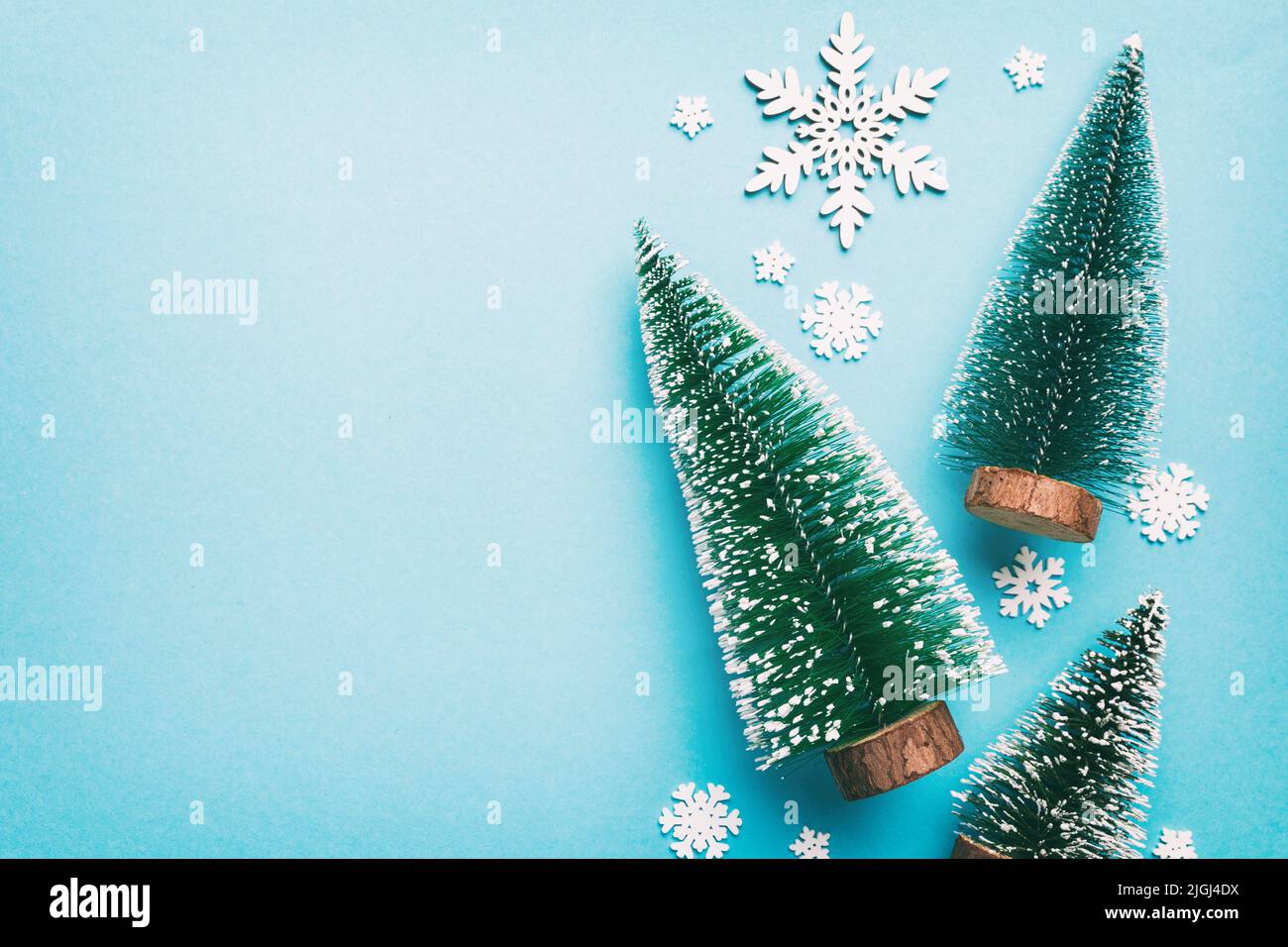 Flat lay composition with christmas trees on color background. Top view ...