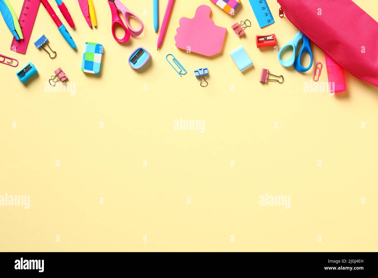 Back to school concept. Frame made of school essentials on yellow ...